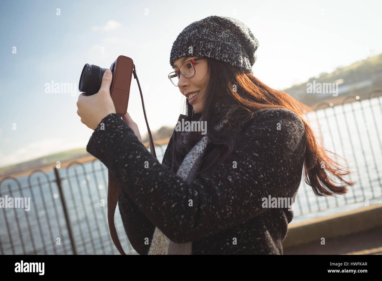 Smiling woman taking photos on digital camera Stock Photo - Alamy