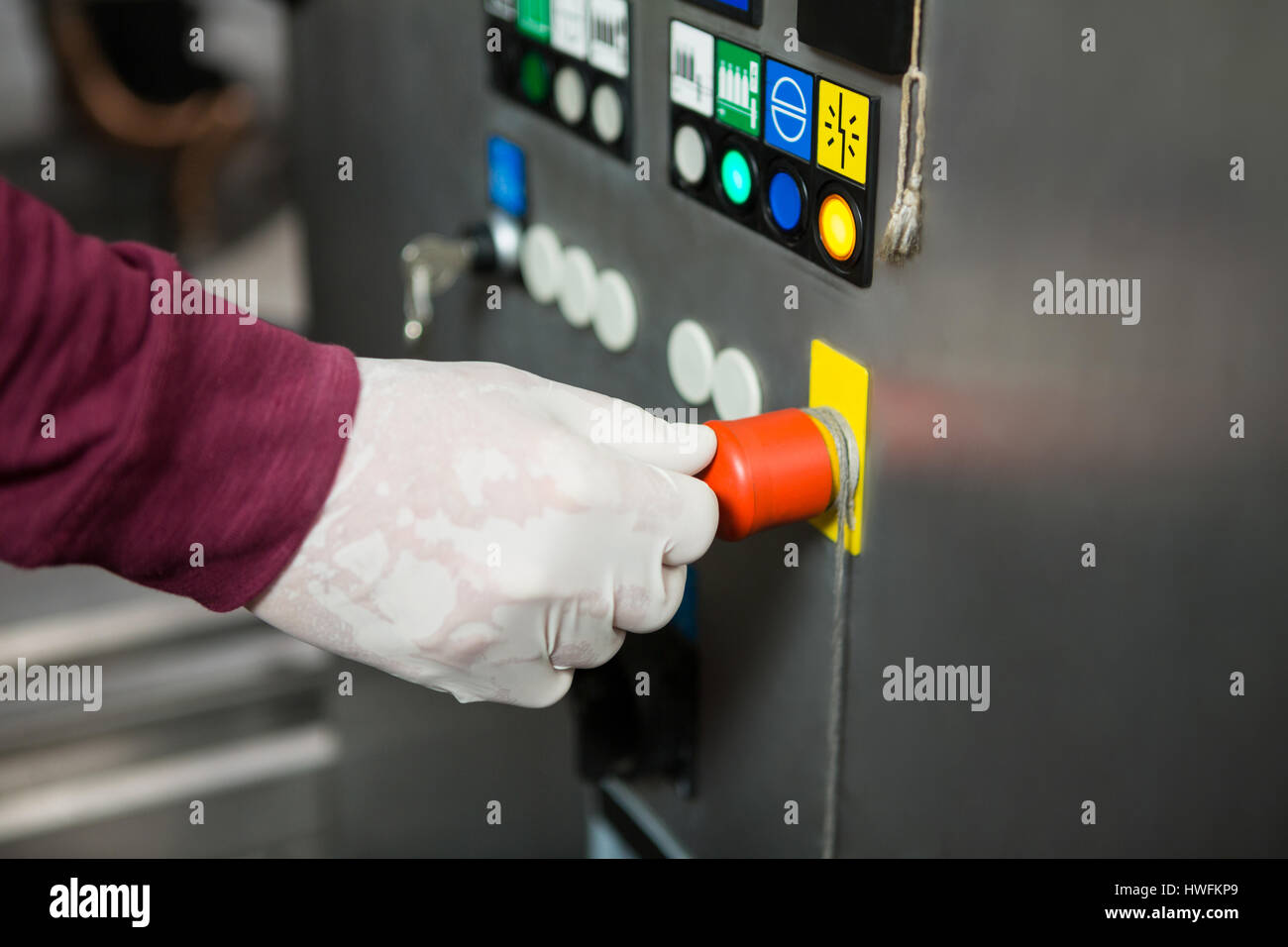 Worker operating machinery in manufacturing hi-res stock photography ...
