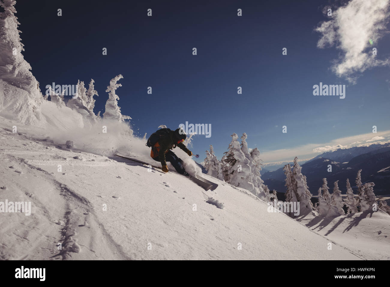 Skier skiing in snowy alps during winter Stock Photo - Alamy