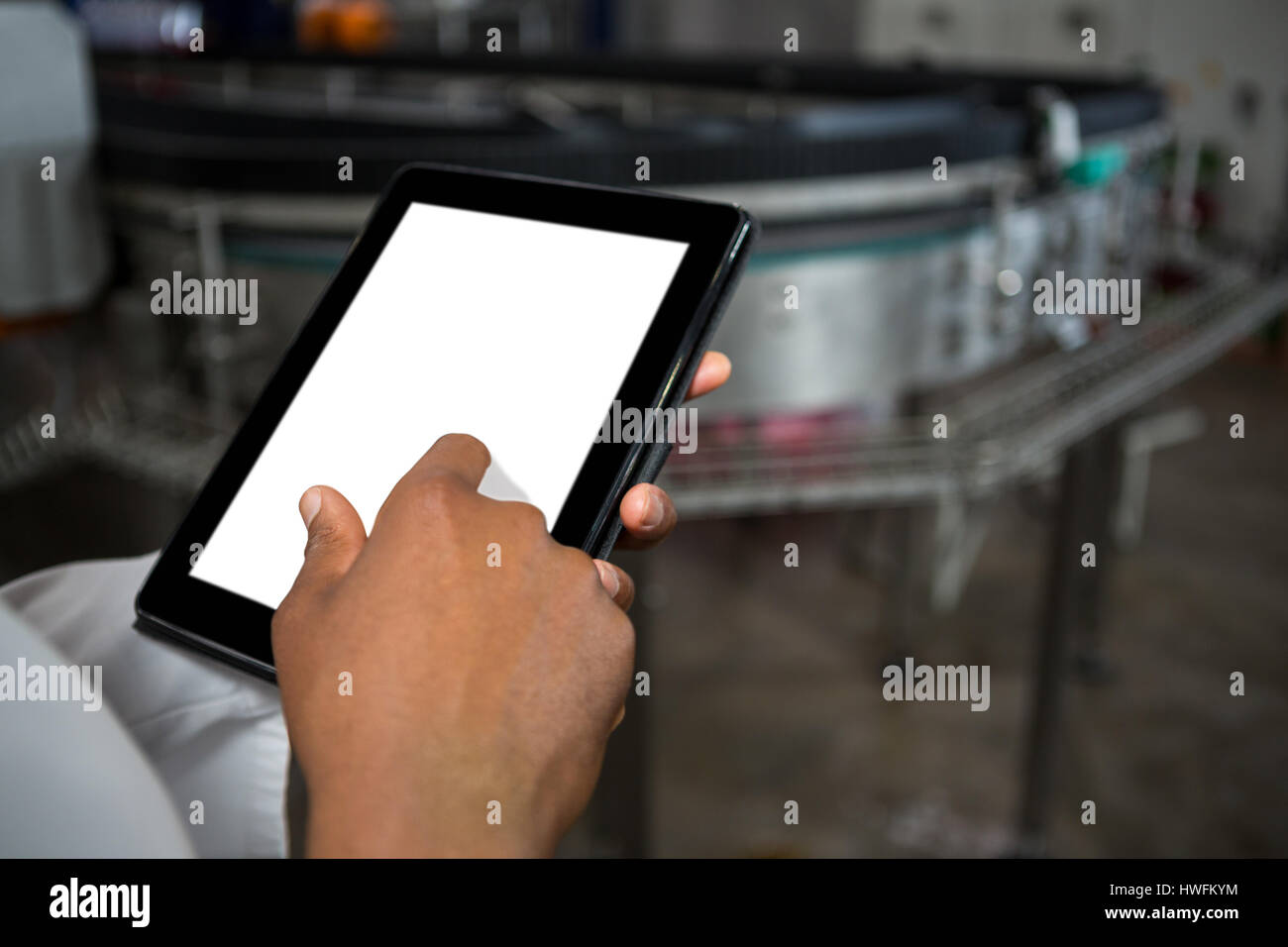 Mid section of male worker using digital tablet in warehouse Stock ...