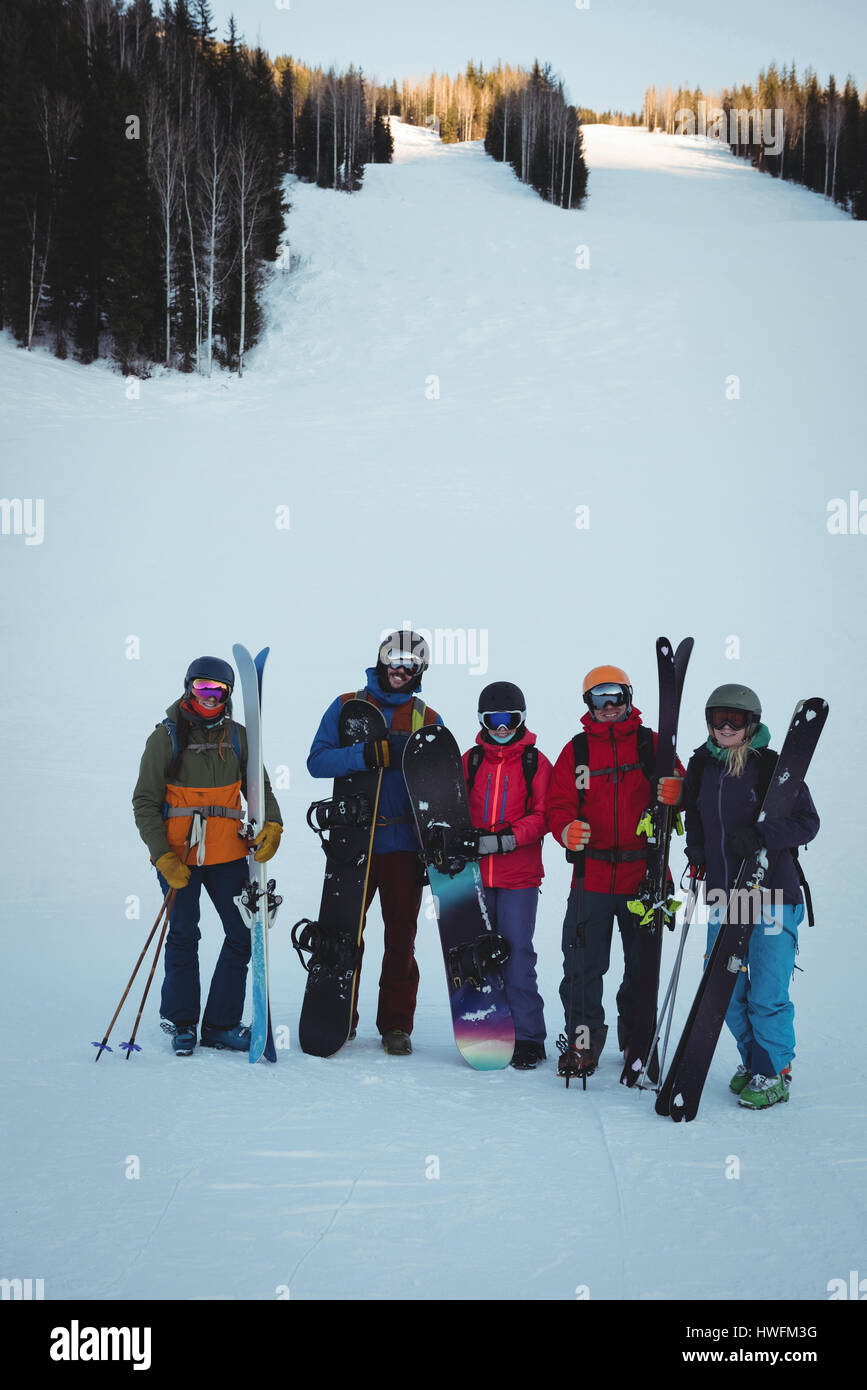 Group of skiers with skies standing on snowy landscape in ski resort ...