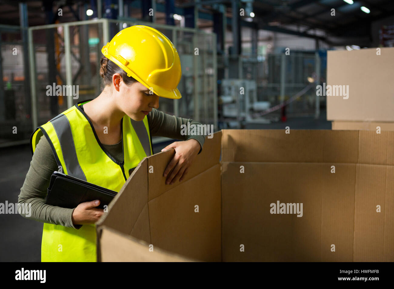 Woman in warehouse checking hi-res stock photography and images - Alamy