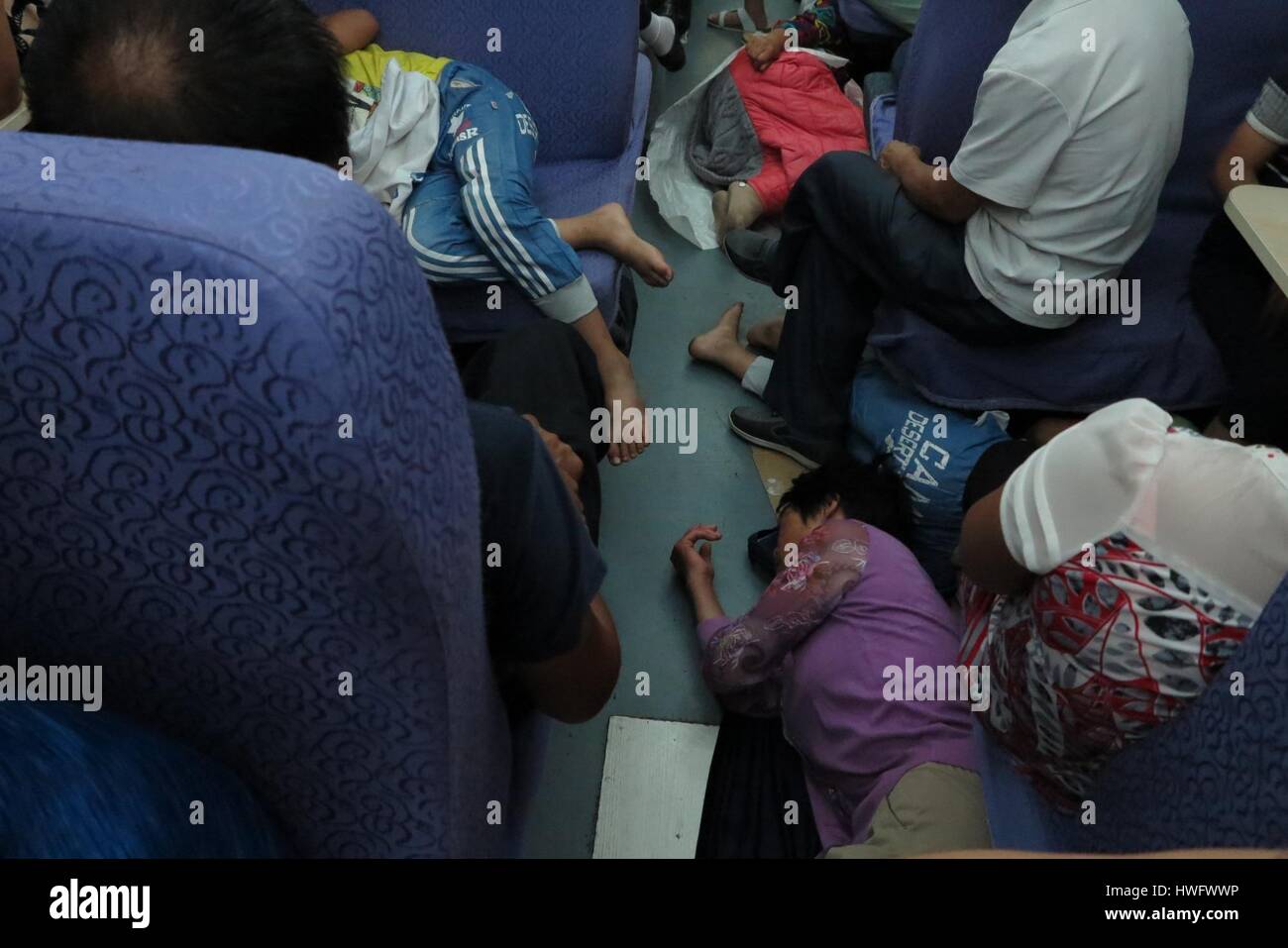 Xian, China. 20th Mar, 2017. Passengers sleep on the corridor of a ...