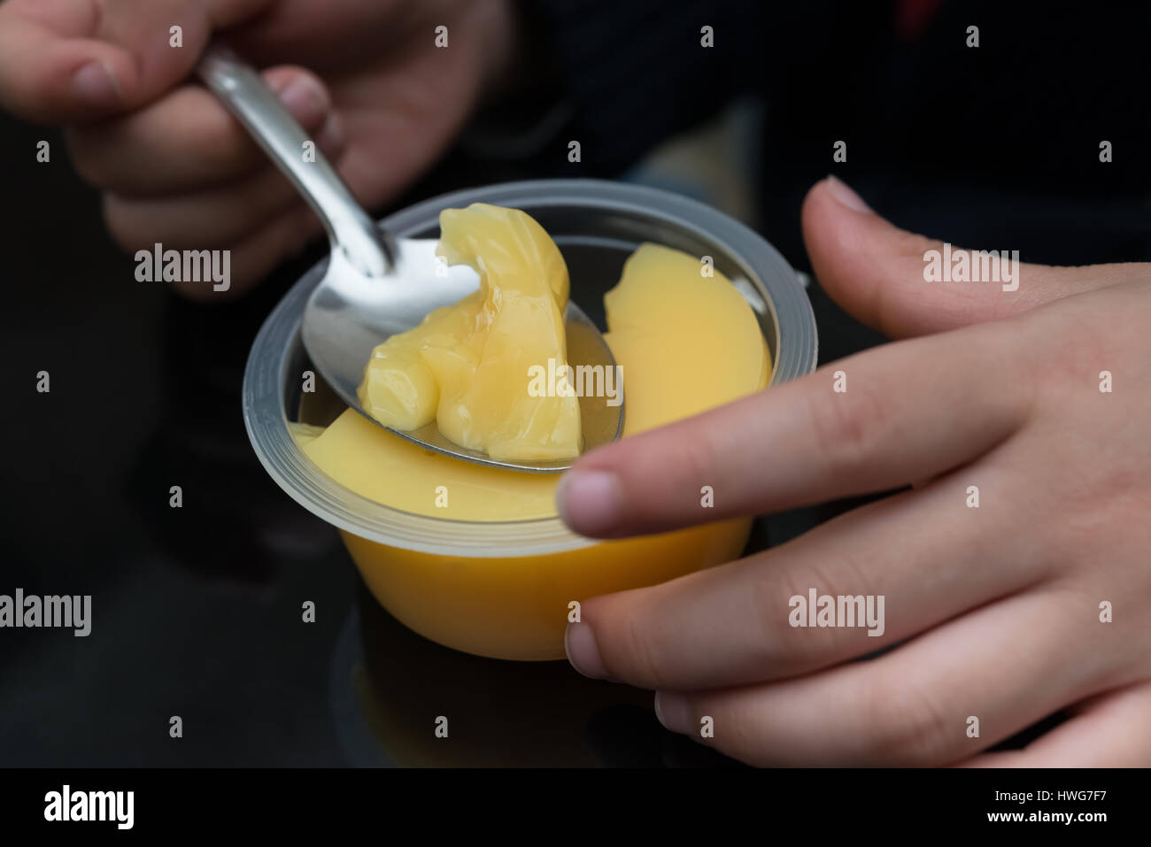 kid eating mango flavor pudding Stock Photo - Alamy