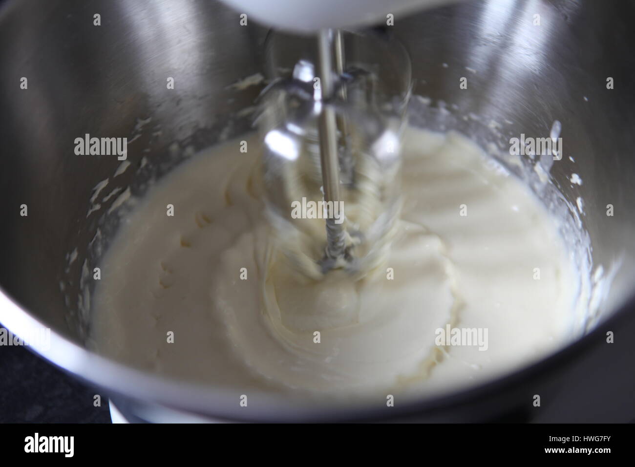 Mixing up the vanilla icing to put in to the sponge cake Stock Photo ...