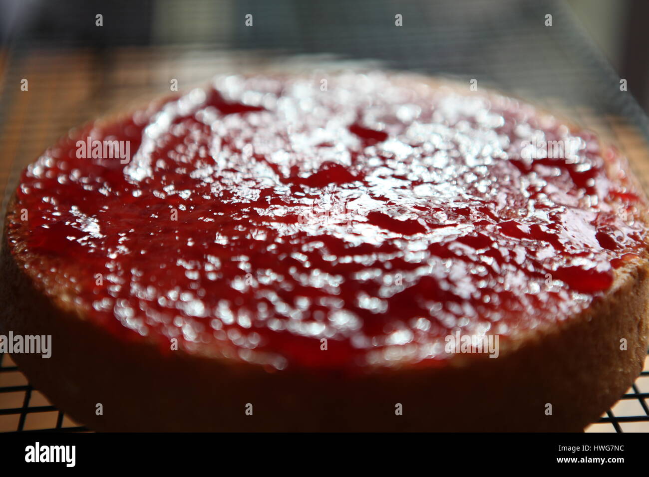 Top half of the victoria sponge cake, covered in jam Stock Photo - Alamy