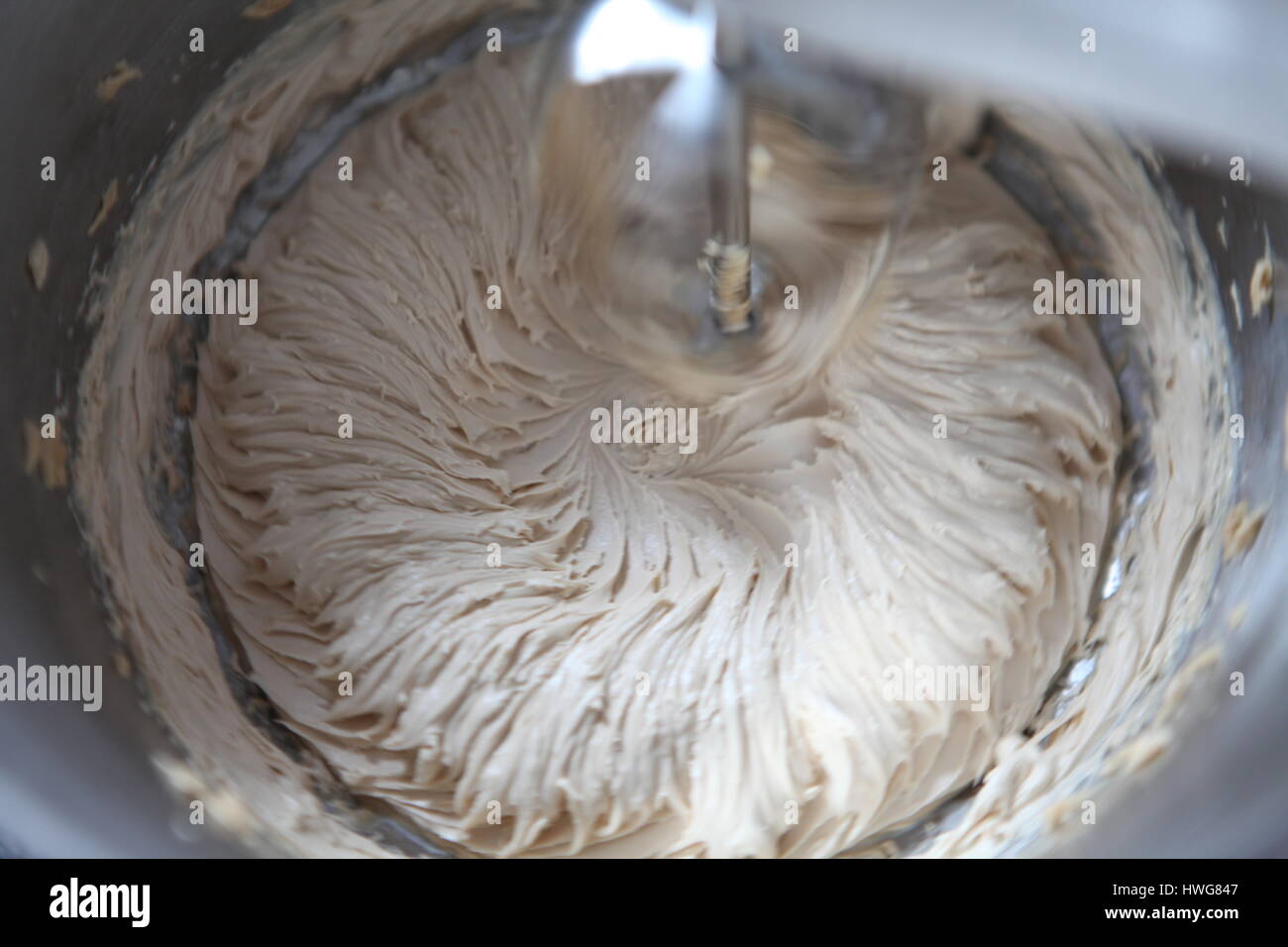 Mixing buttercream icing to top a homemade baked cake Stock Photo - Alamy