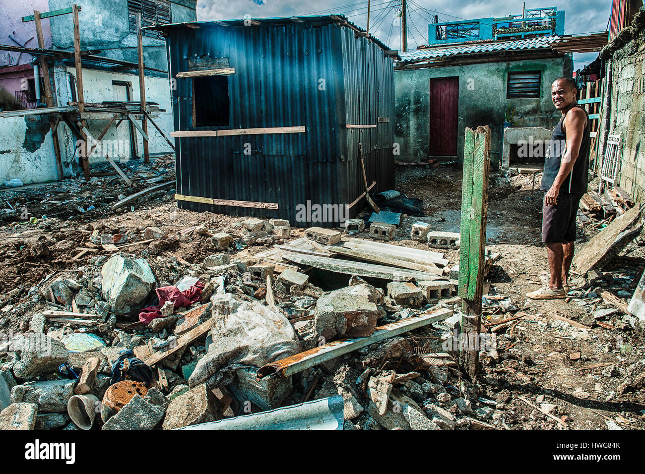 a boy has built a shack on the rubble of his collapsed house after the ...