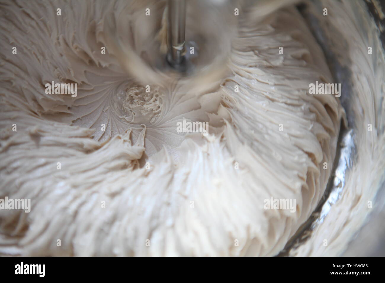 Mixing buttercream icing to top a homemade baked cake Stock Photo - Alamy