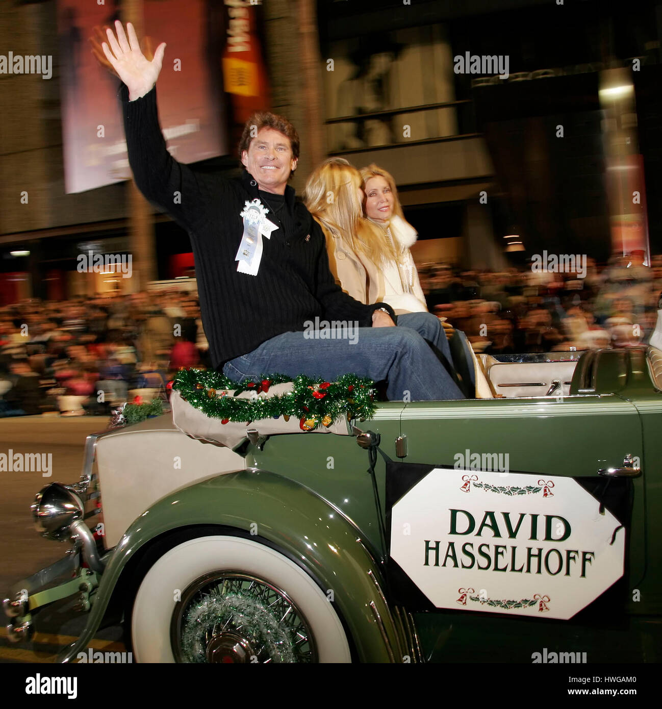 Actor David Hasselhoff, left, waves to the crowd while riding in the ...