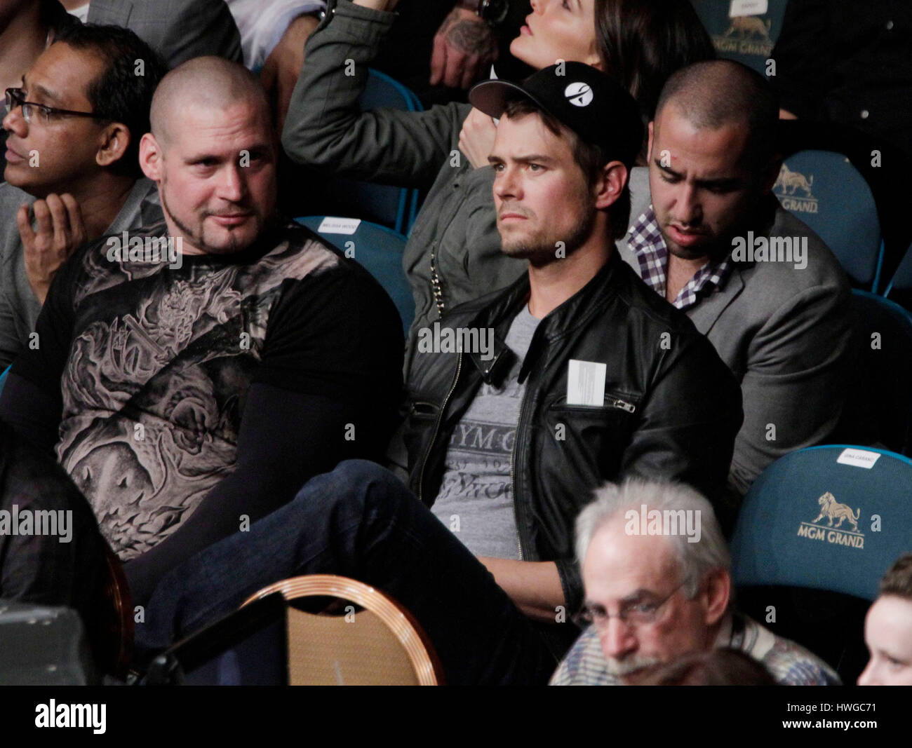 Bodyguard Pascal Duvier, left, watches with actor Josh Duhamel cage ...