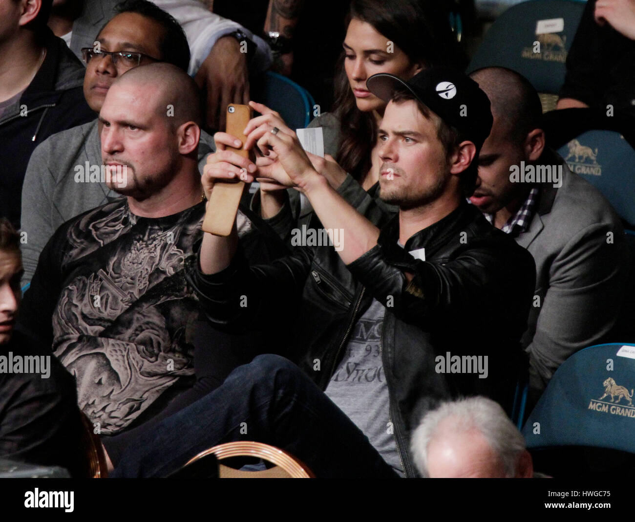 Bodyguard Pascal Duvier, left, watches the matches as actor Josh ...