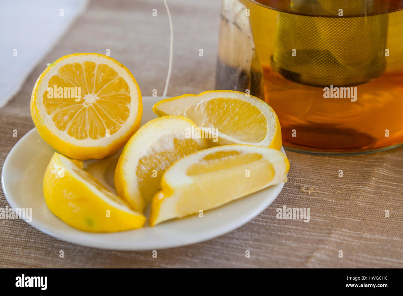 Closeup of sliced lemons close to a tea cup Stock Photo - Alamy