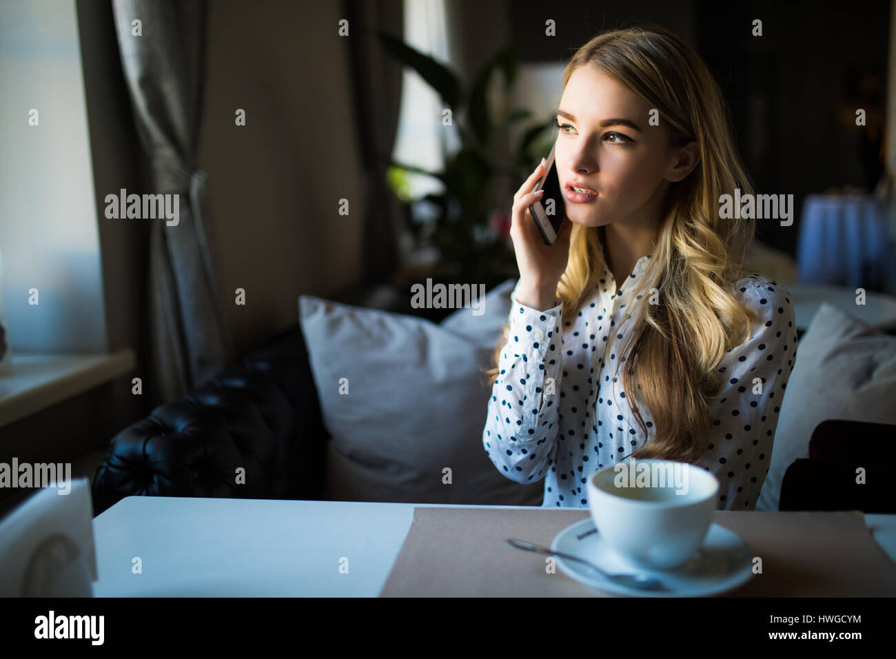 charming lady with beautiful smile talking on cell telephone while ...