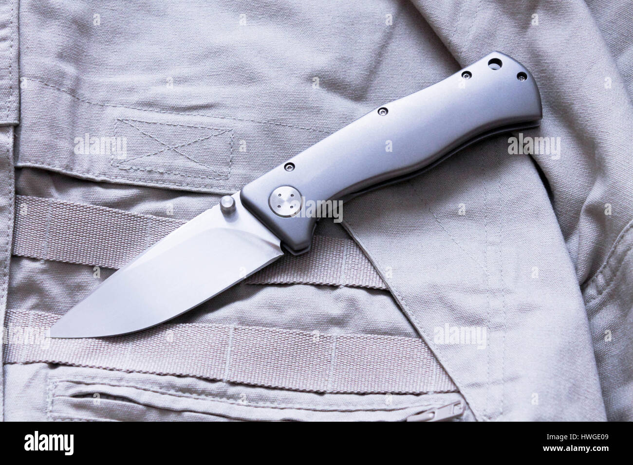 Pocket knife on cloth background. Sharp blade Stock Photo - Alamy