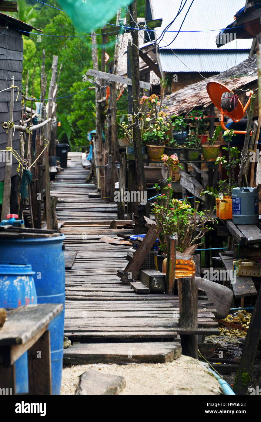 Deacking beside a house in the village of Makyone Galet, Lampi National ...