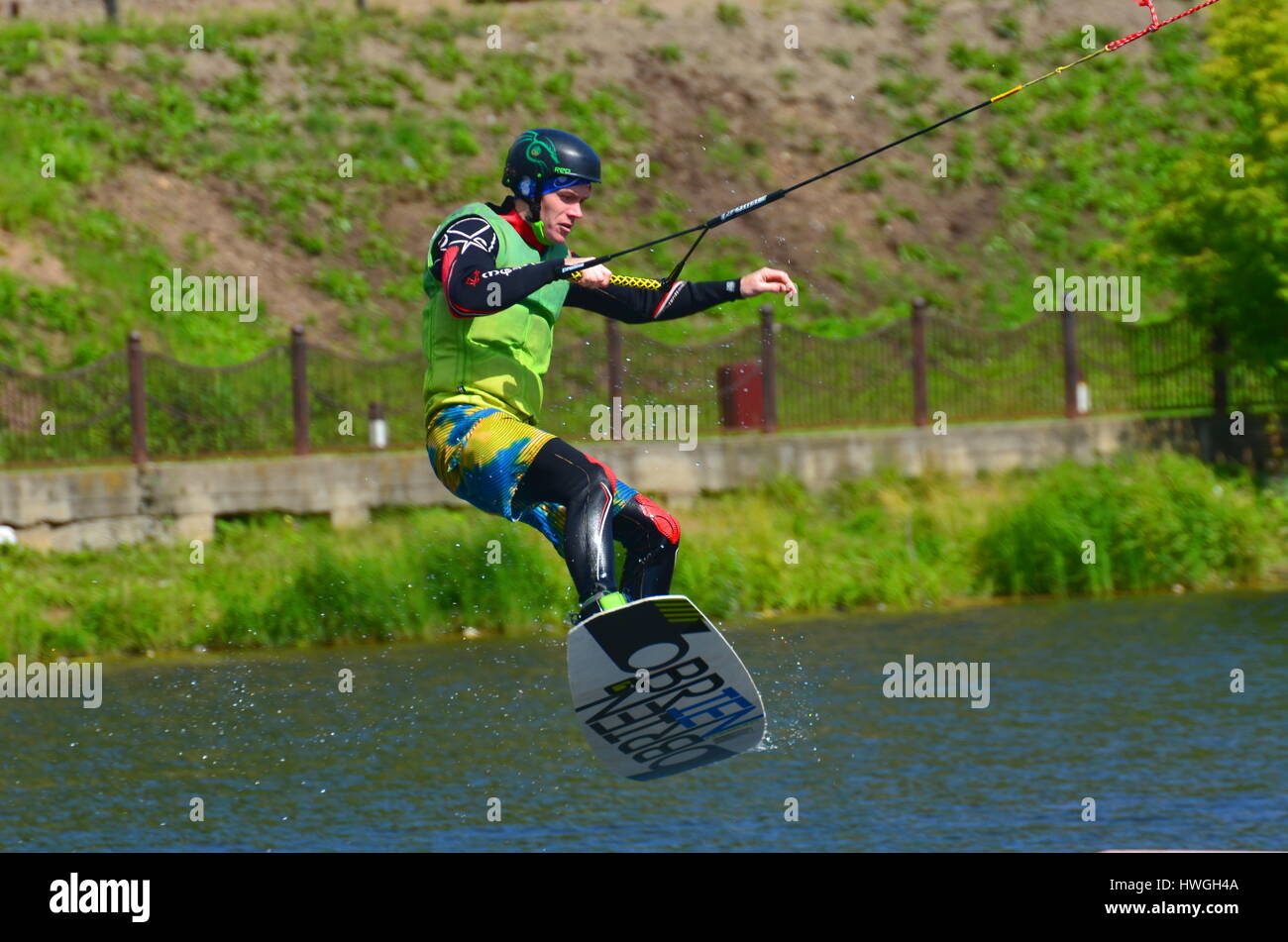 Water snowboard. The athlete with snowboard hold on to the rope and the ...