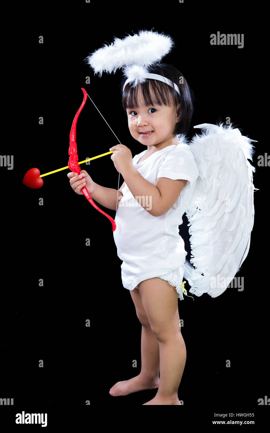 Happy Asian Chinese Little Angel WIth Bow And Arrow in isolated dark ...
