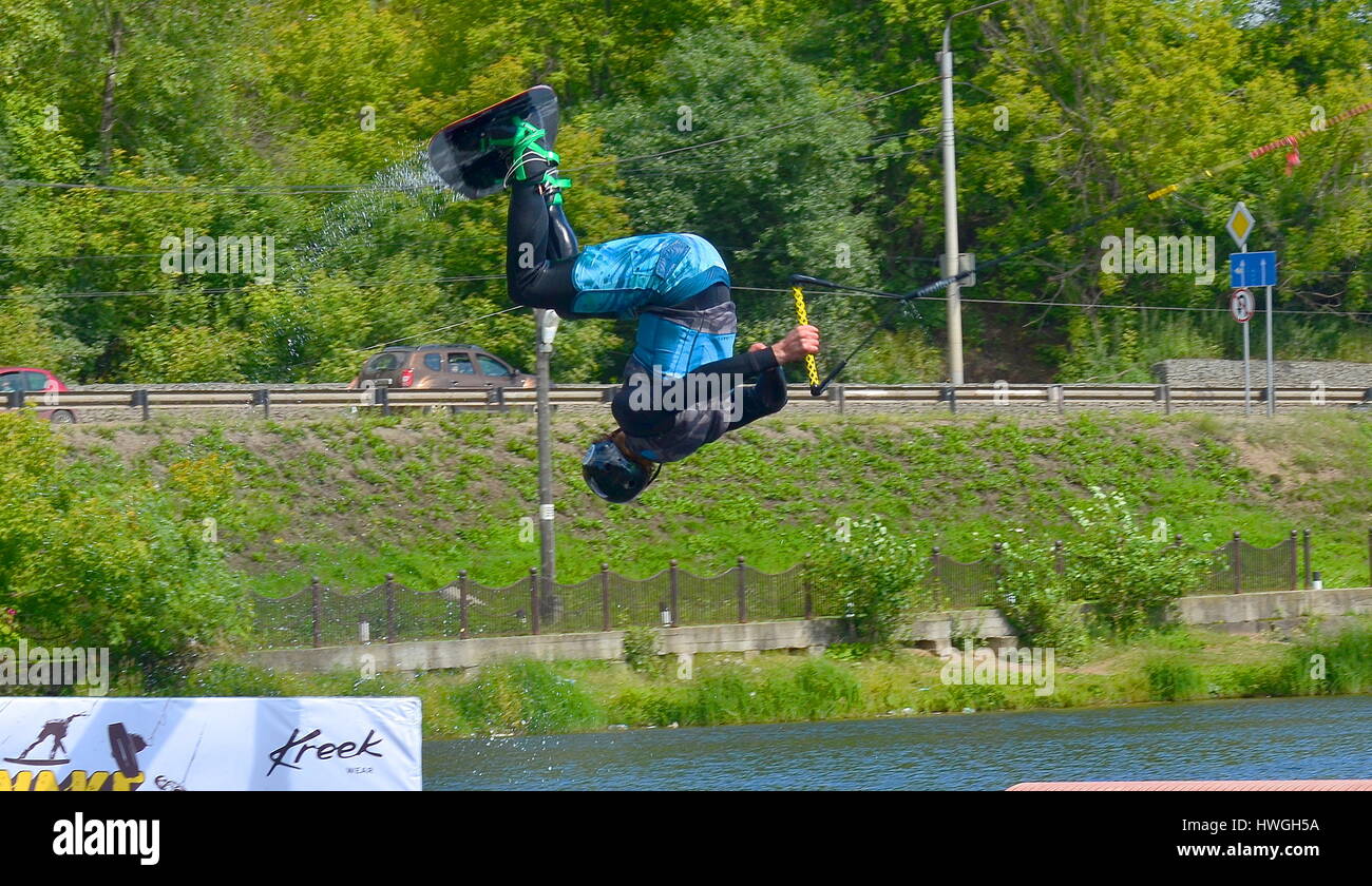 Water snowboard. The athlete with snowboard hold on to the rope and the ...