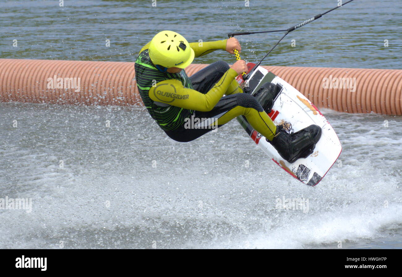 Water snowboard. The athlete with snowboard hold on to the rope and the ...