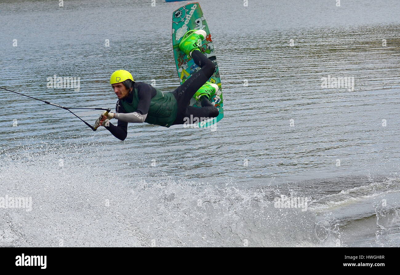 Water snowboard. The athlete with snowboard hold on to the rope and the ...