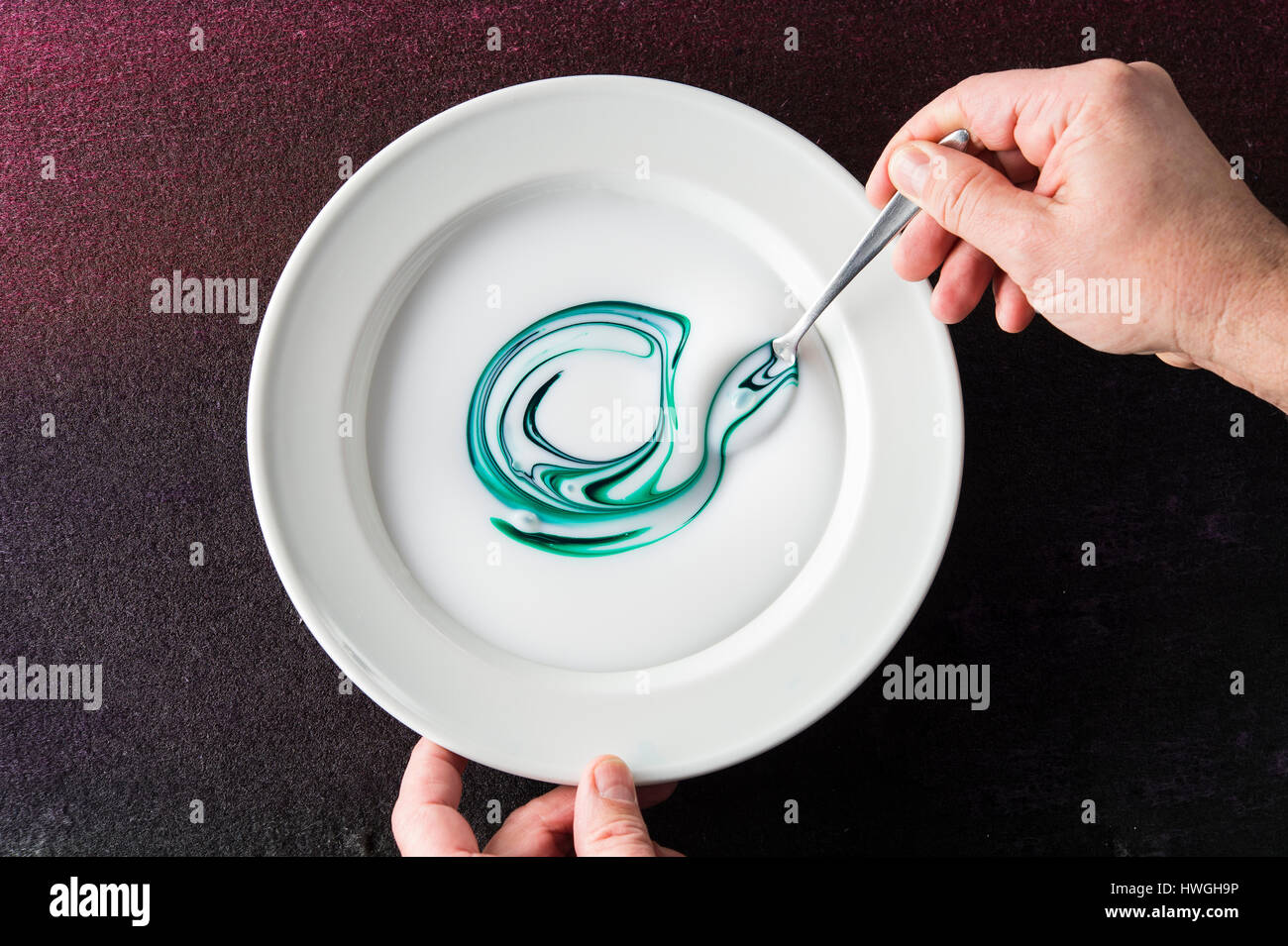 Block printing, hand mixing green pigment color and white binder with ...