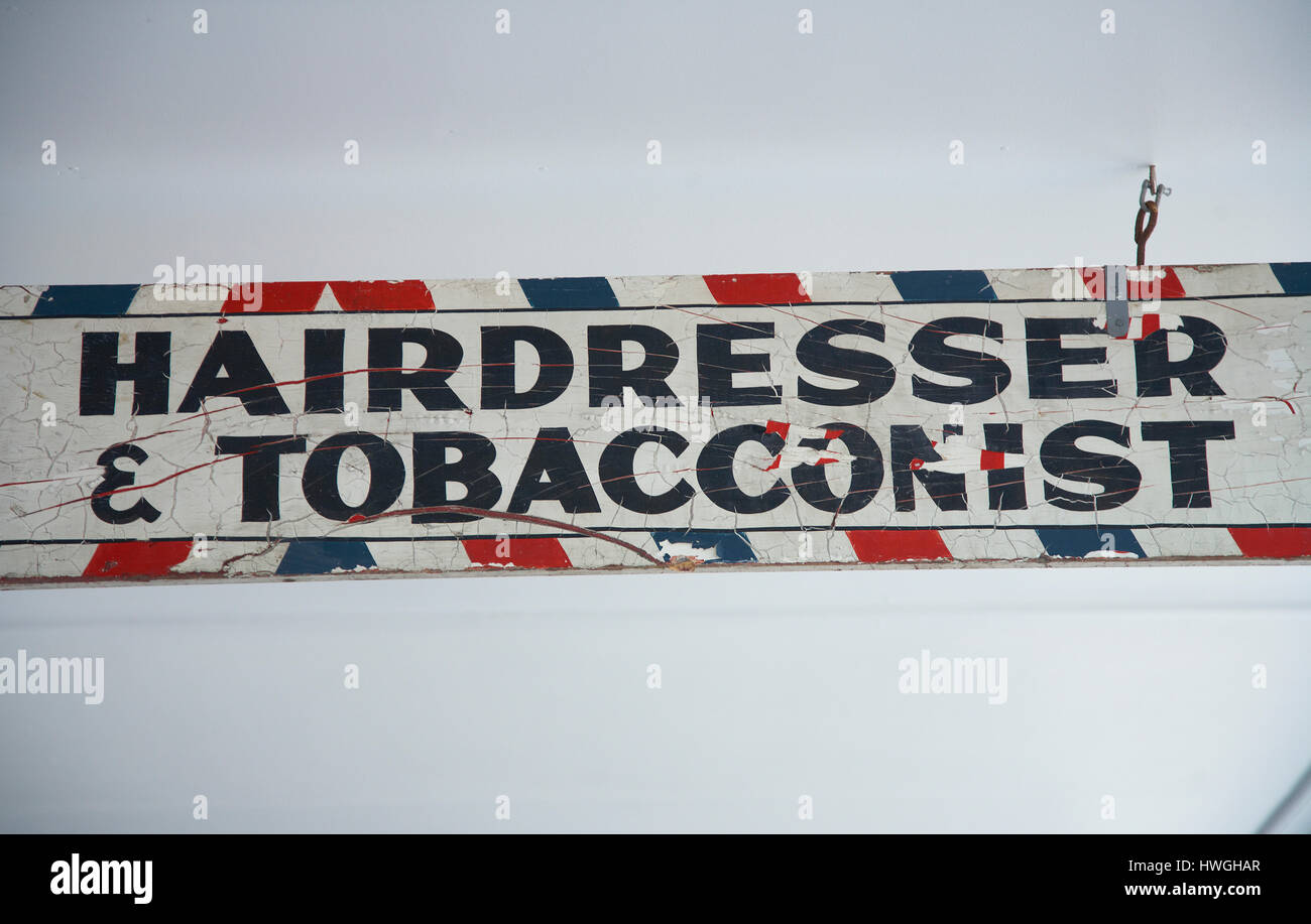 Traditional and hairdresser and tobacconist sign Stock Photo - Alamy
