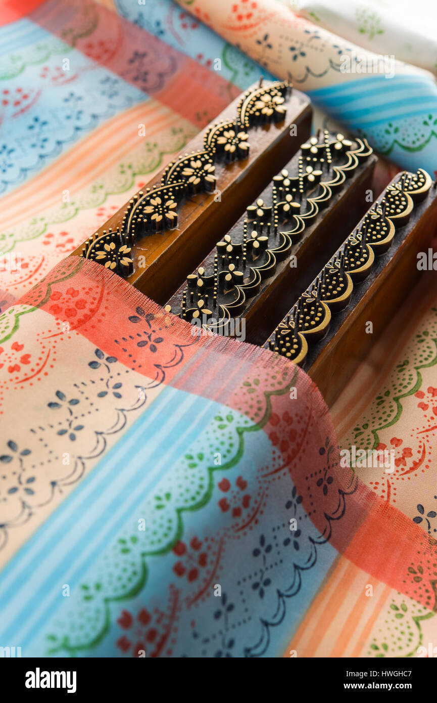 Block printing, three woodblocks with patterns and finished printed ...