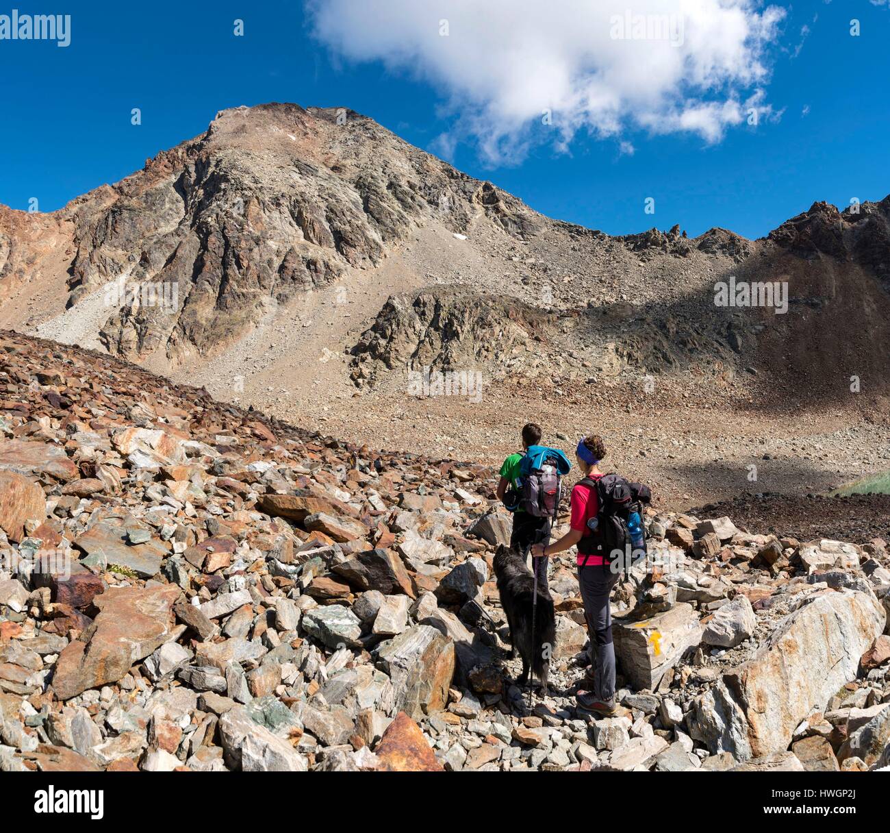 Italy, Valle d'Aosta, Aosta, Pila, Hikers couple walking in the valley ...