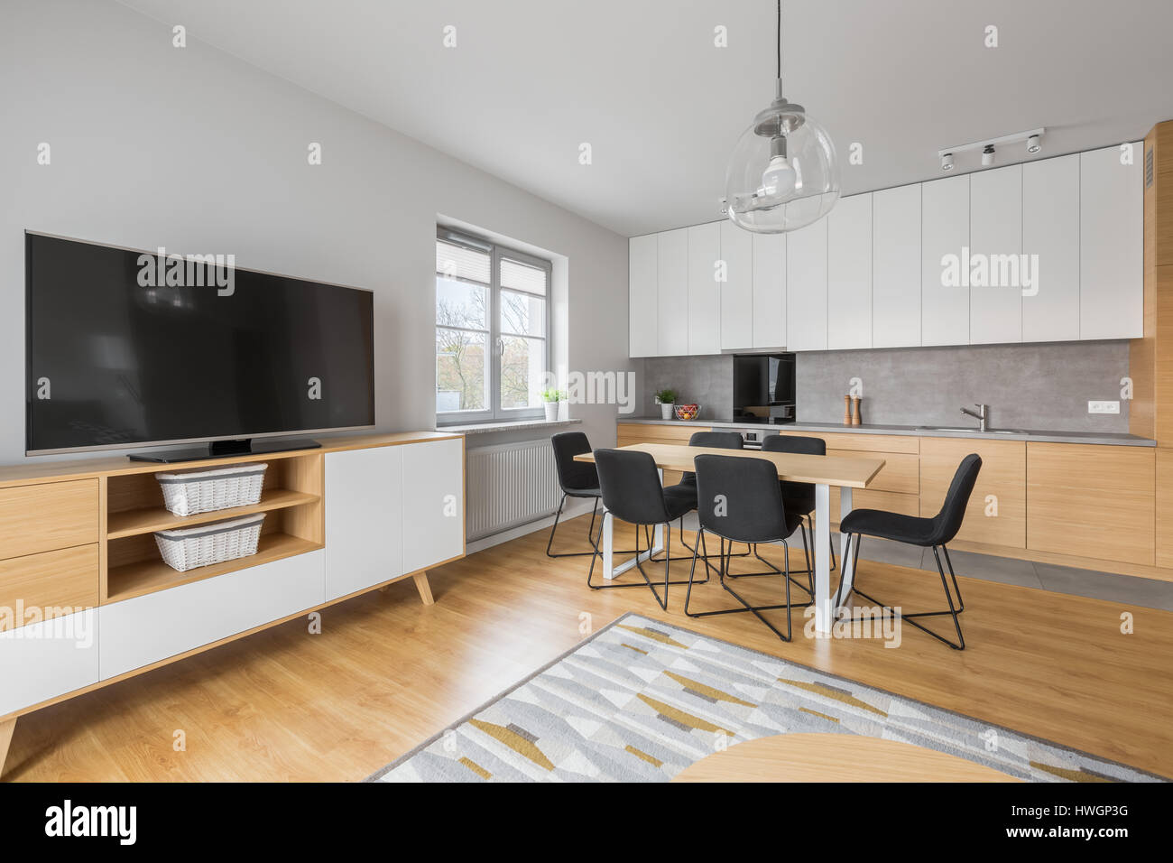 Interior of kitchen with dining space and tv screen Stock Photo - Alamy