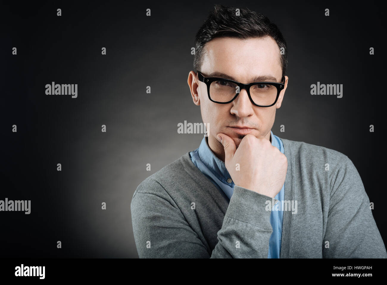 Serious young man wearing glasses Stock Photo - Alamy