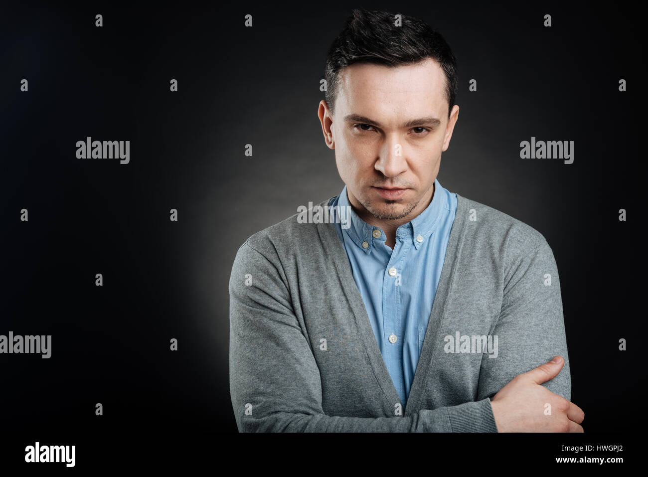 Suspicious young man looking angrily on camera Stock Photo - Alamy