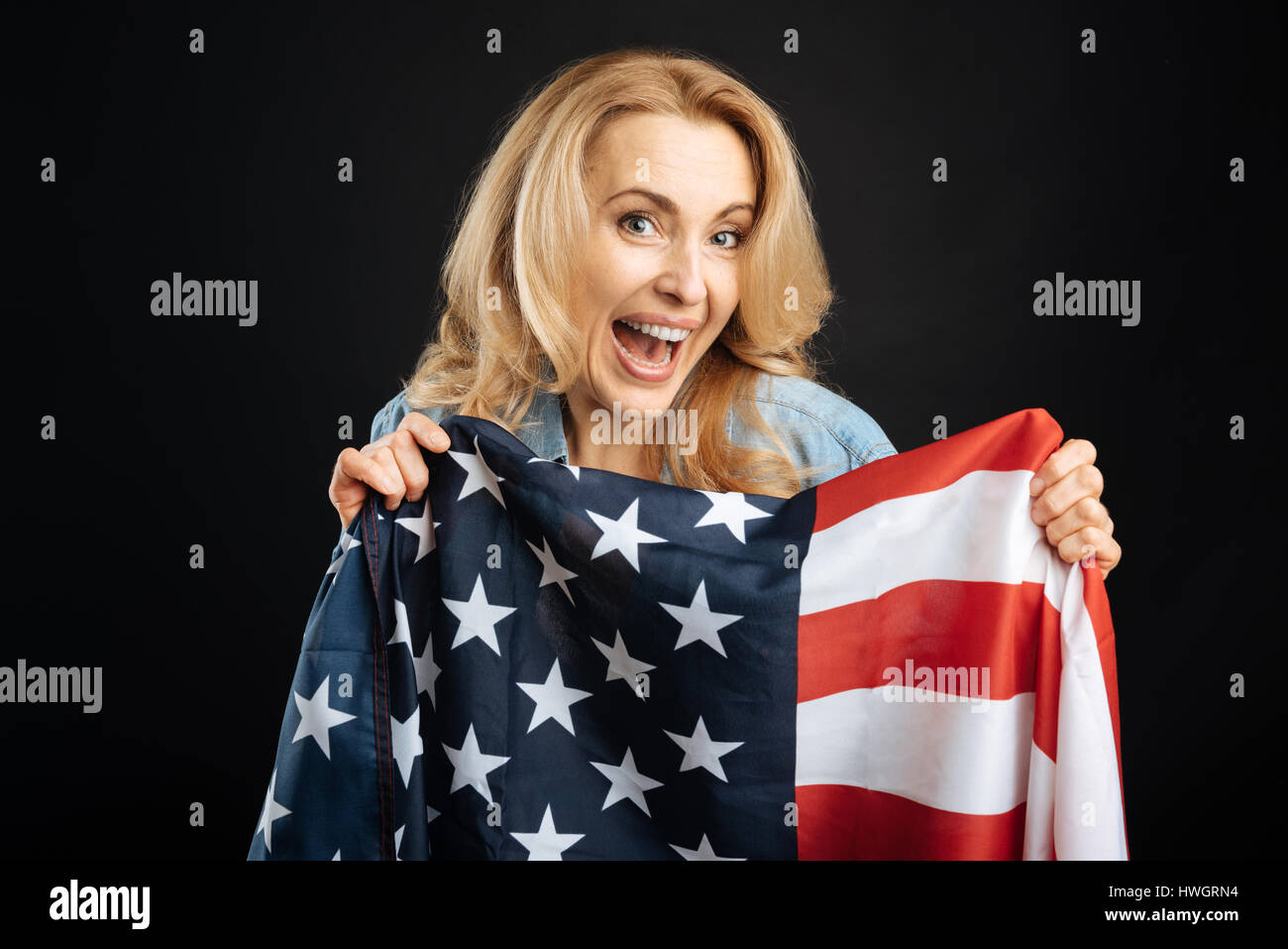 Happy woman showing American flag Stock Photo - Alamy