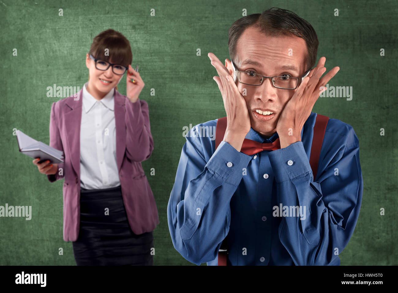 Asian nerd man looking shy with beautiful teacher behind him on class ...