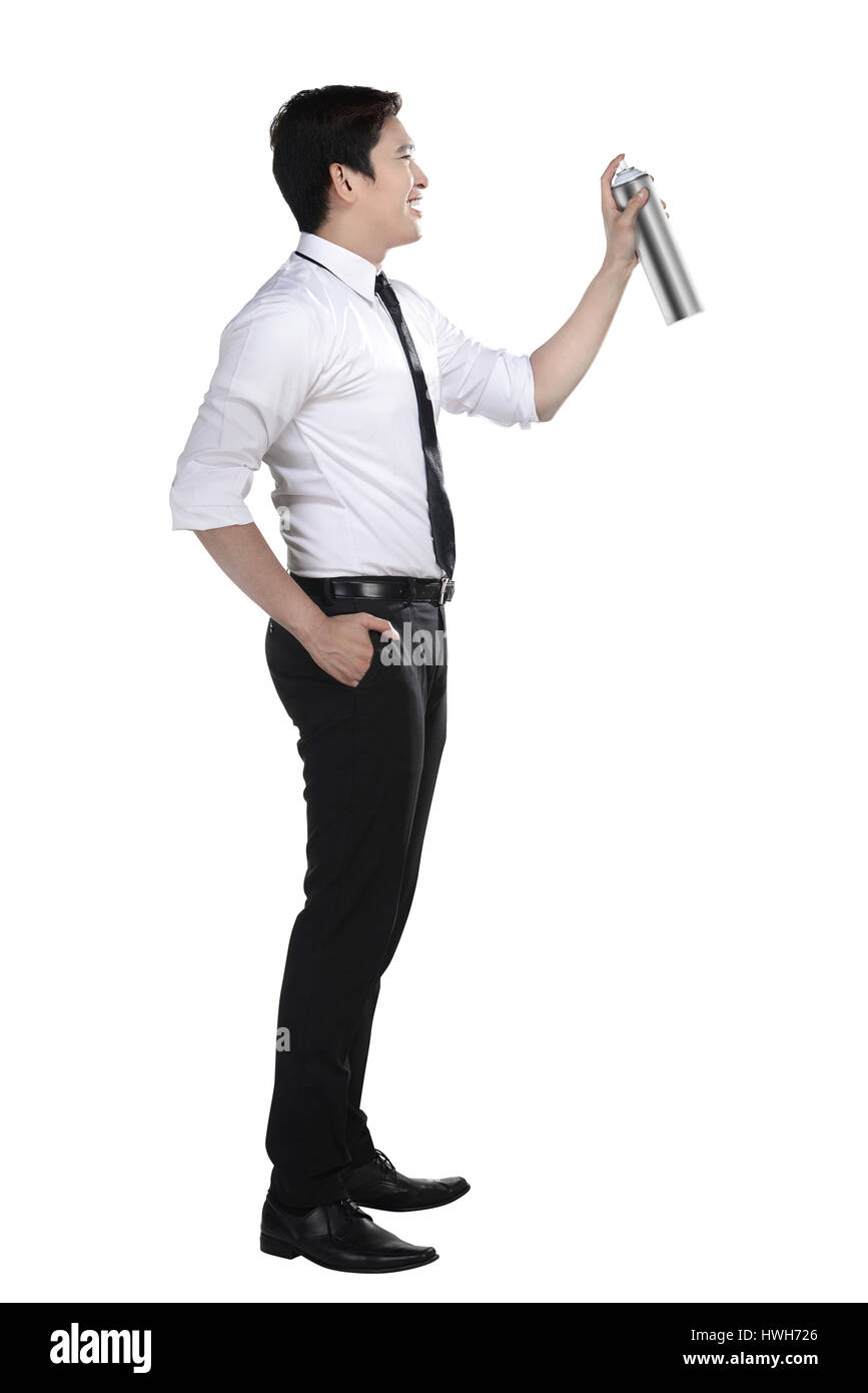 Asian business man spraying something isolated over white background ...