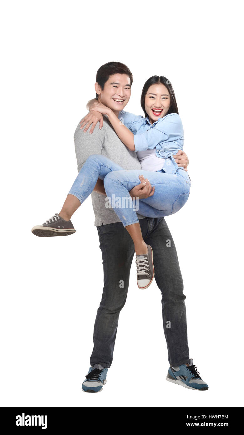 Young man carrying his laughing partner isolated over white background ...