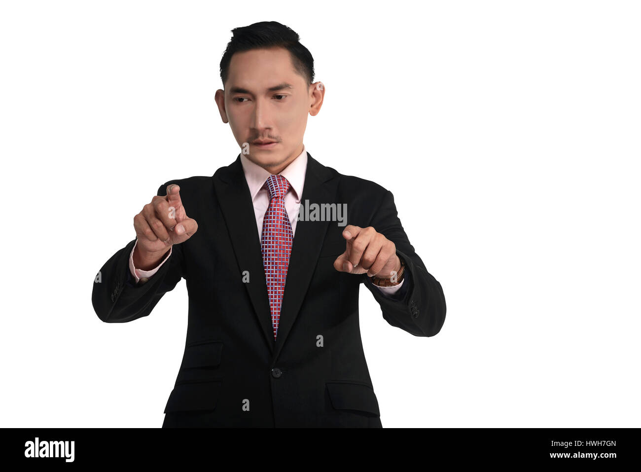 Asian business man pointing something isolated over white background ...