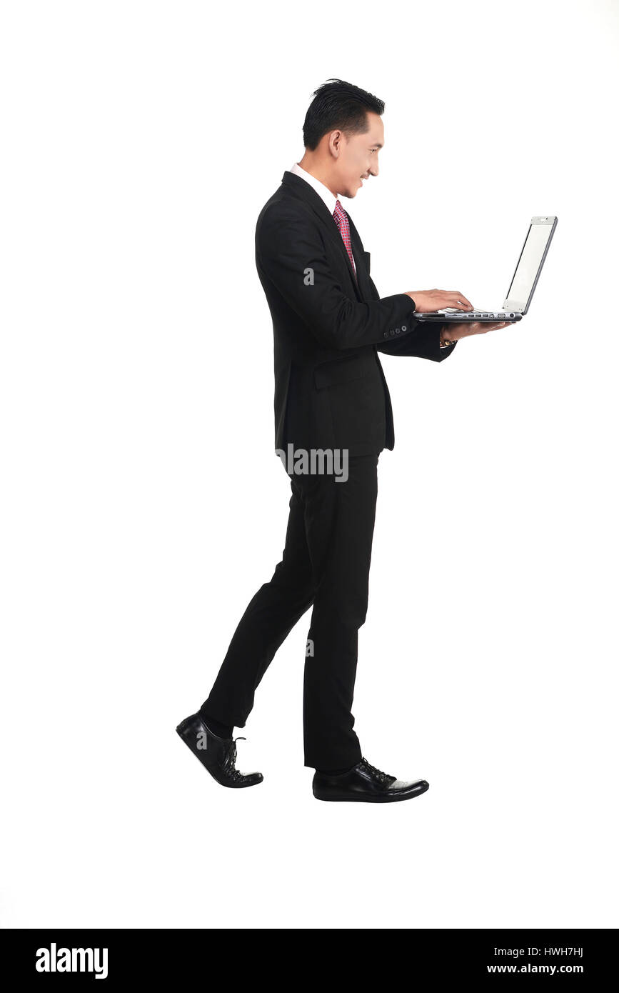 Business man standing working with laptop isolated over white ...