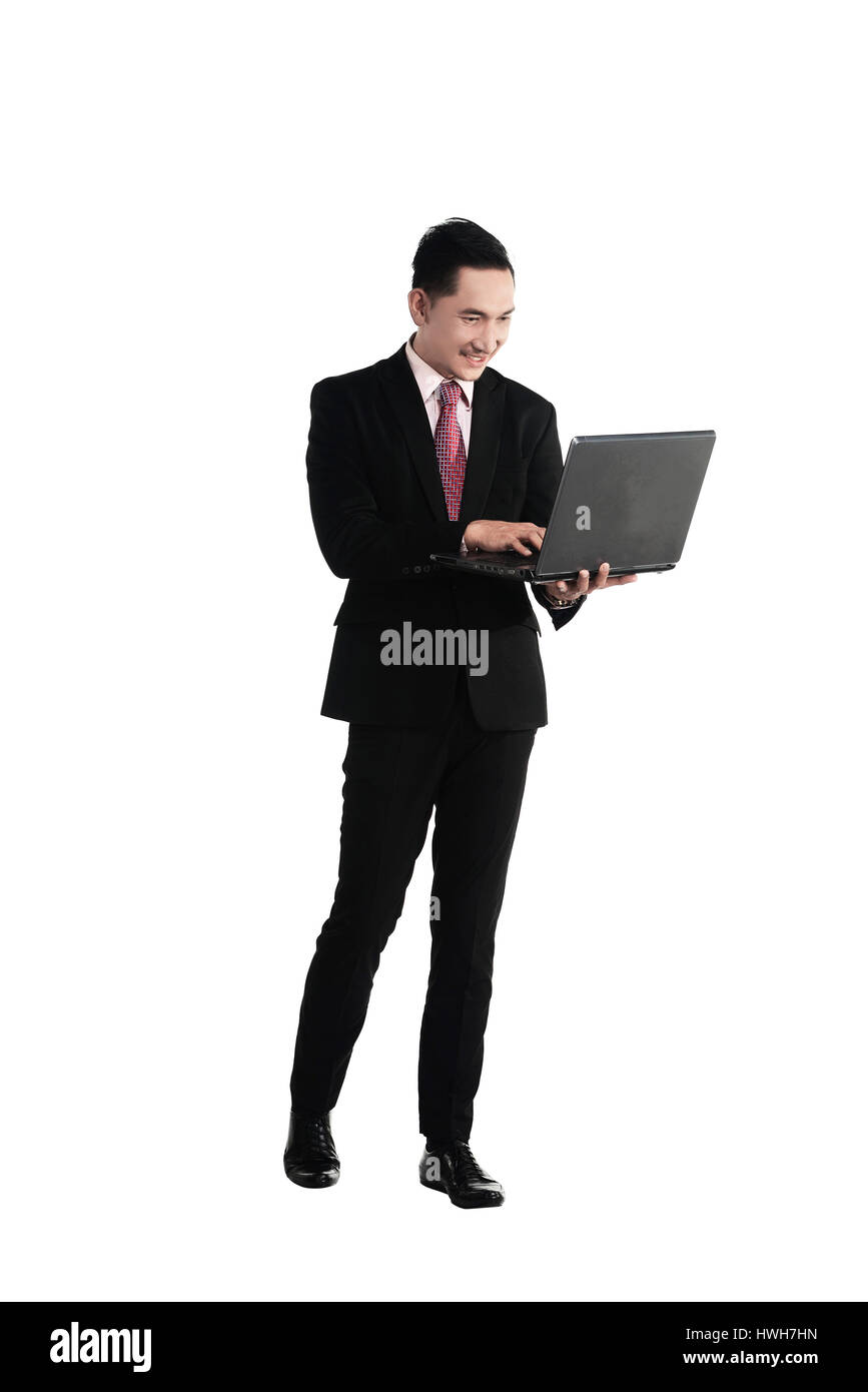 Asian business man holding laptop isolated over white background Stock ...