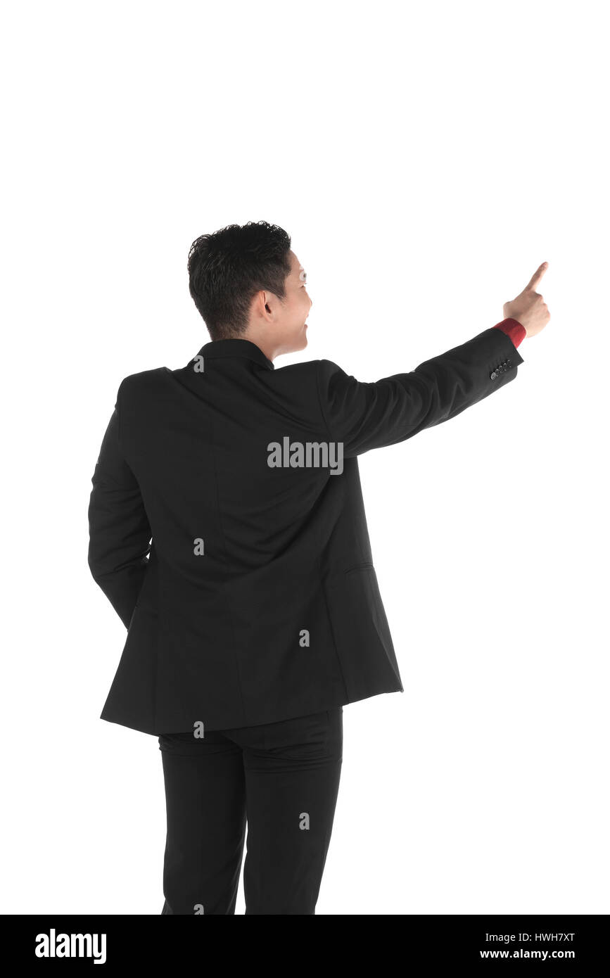 Asian business man pointing something isolated over white background ...