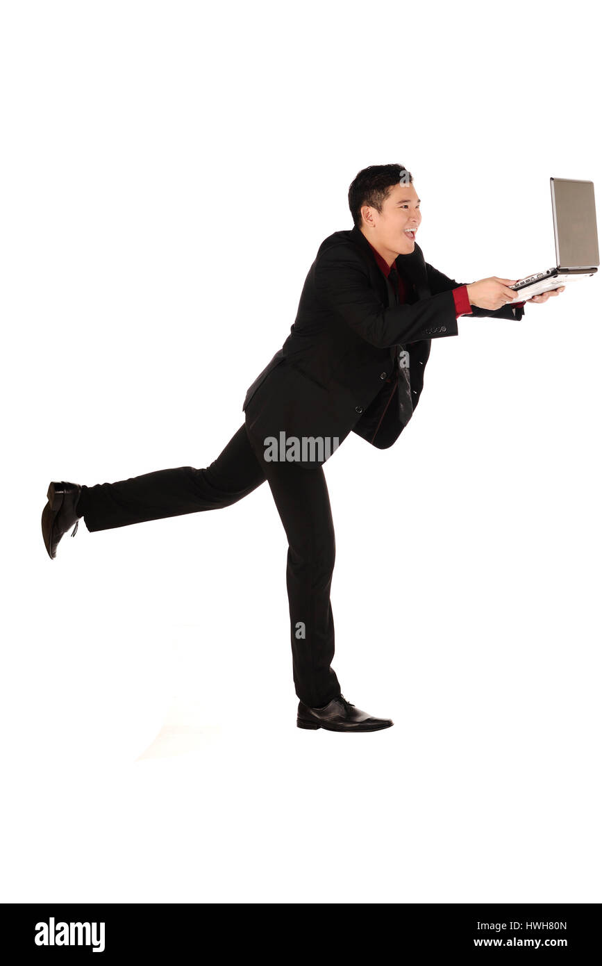 Asian business man run holding laptop isolated over white background ...