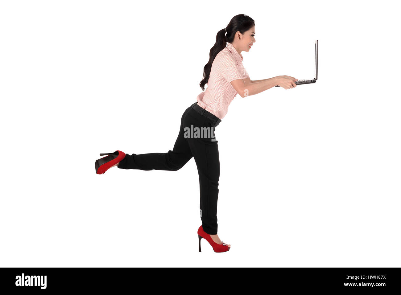 Asian business woman using laptop while running isolated over white ...