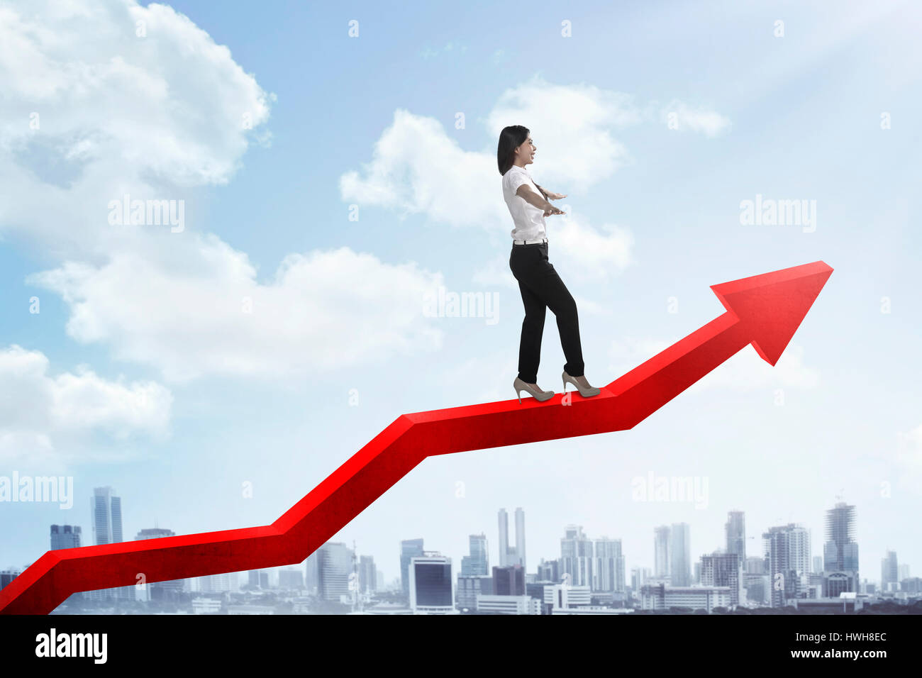 Asian business woman balancing the increasing chart Stock Photo - Alamy