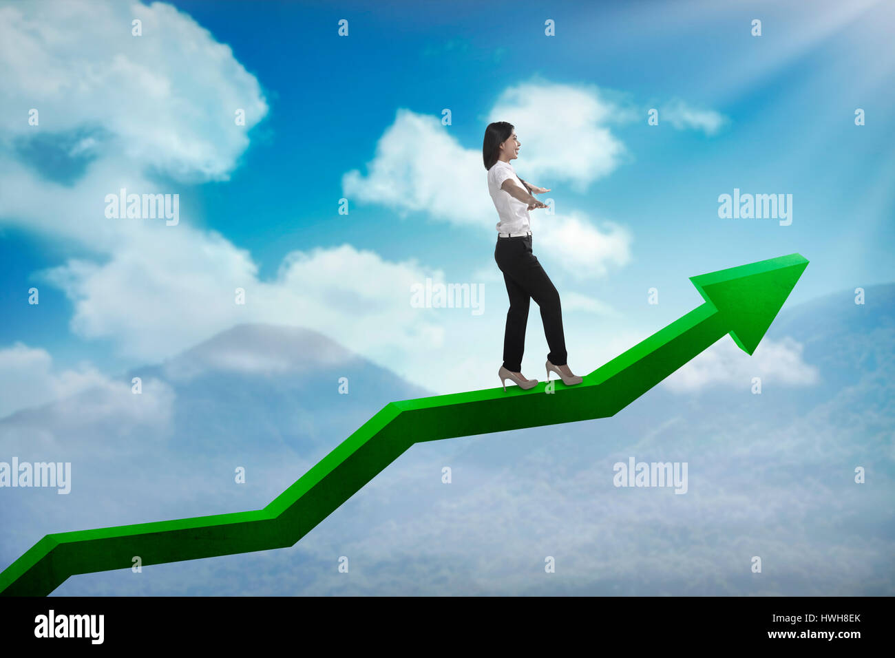 Asian business woman balancing the increasing chart Stock Photo - Alamy