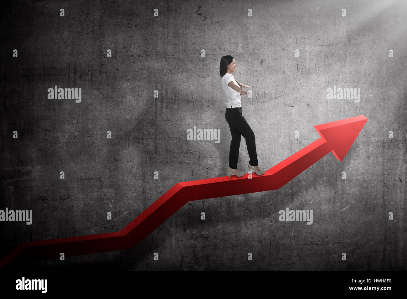 Asian business woman balancing the increasing chart Stock Photo - Alamy