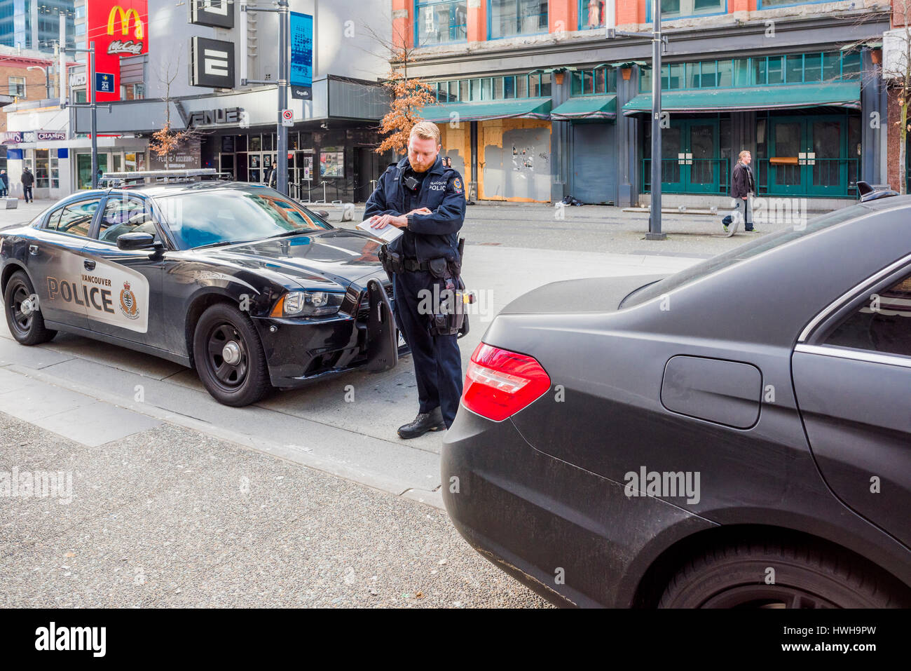 Police Officer in proces of issuing a traffic violation ticket ...