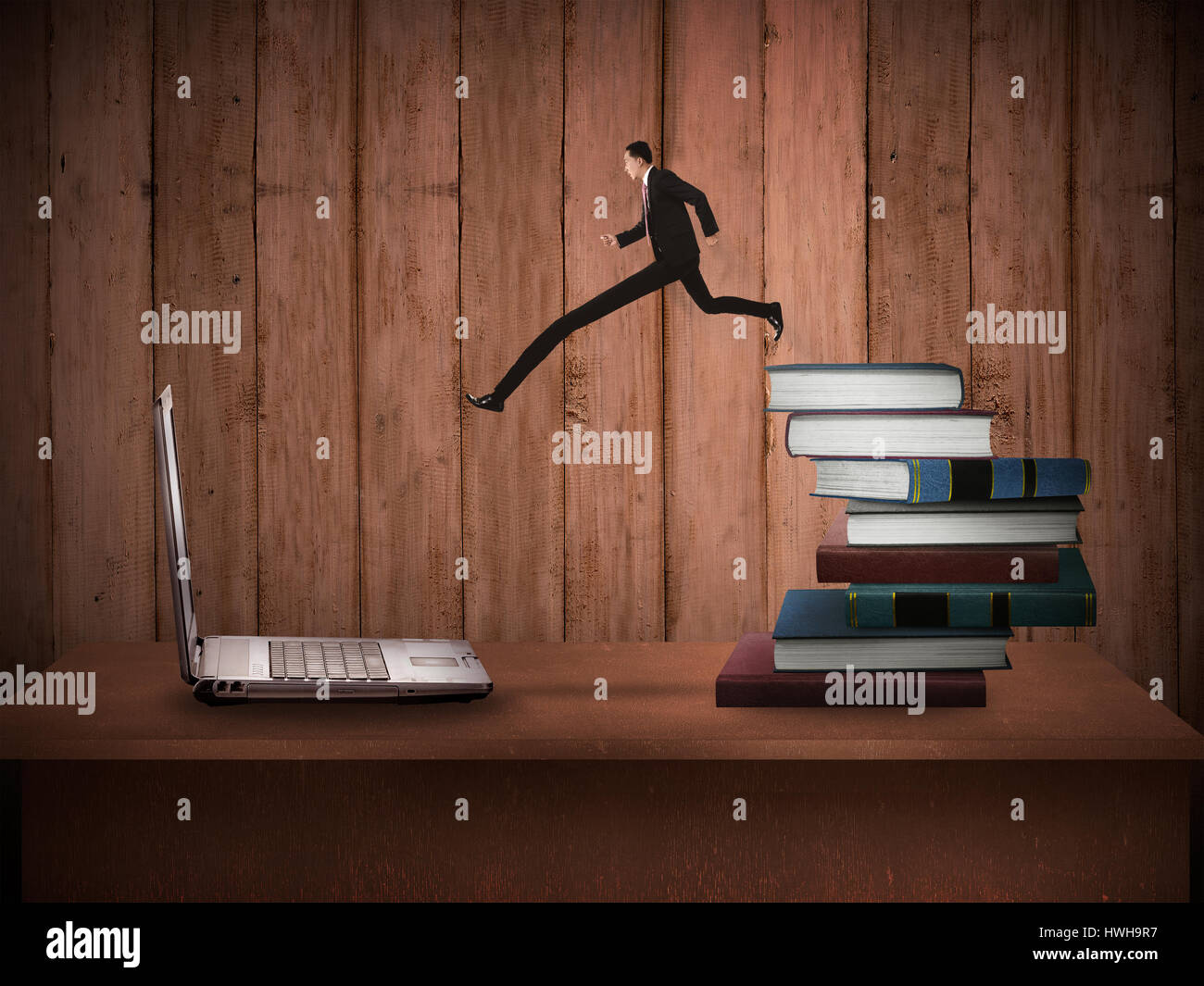 Concept of technology migration with business person jumping from book ...