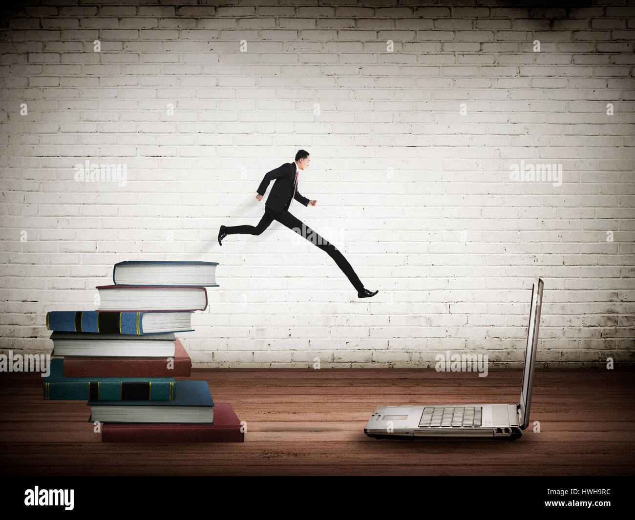 Concept of technology migration with business person jumping from book ...
