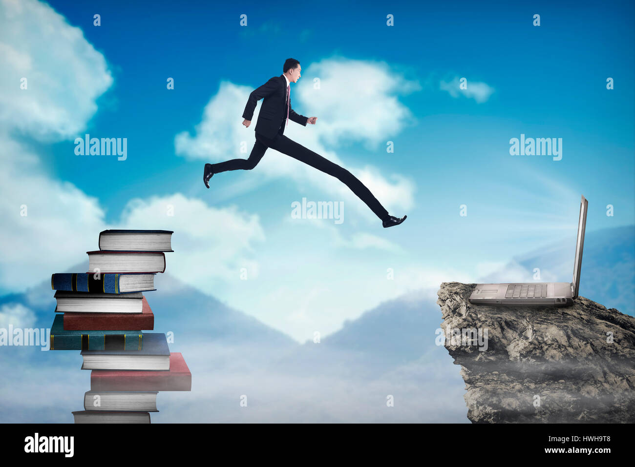Concept of technology migration with business person jumping from book ...