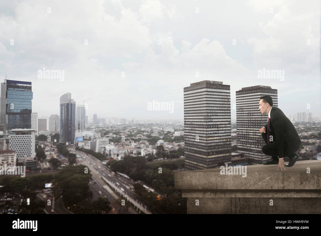 Asian man watching something on the building rooftop in the city Stock ...